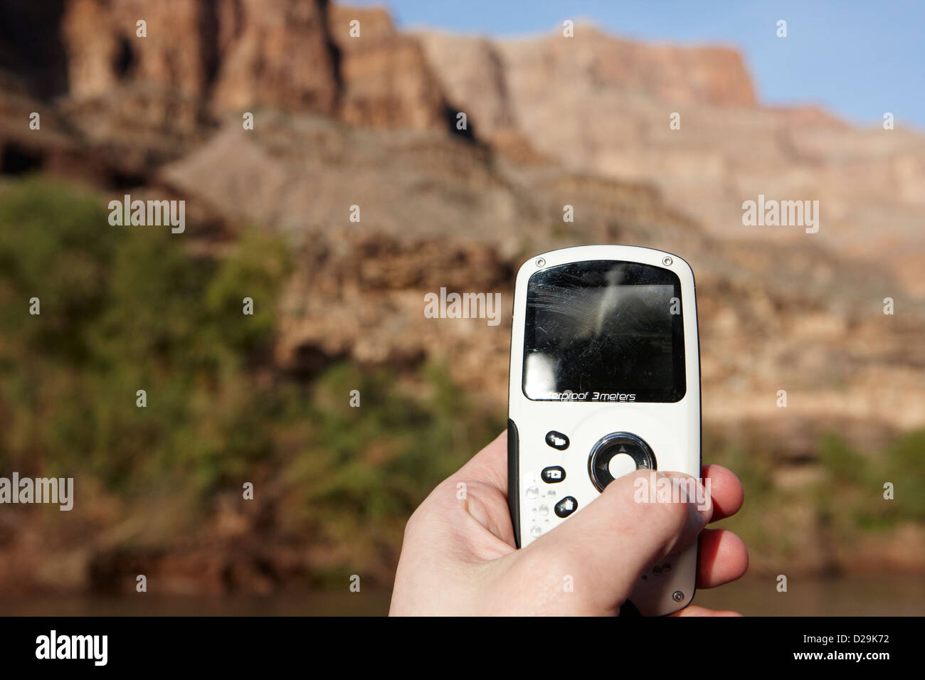 man taking photos and video during boat ride along the colorado river ...