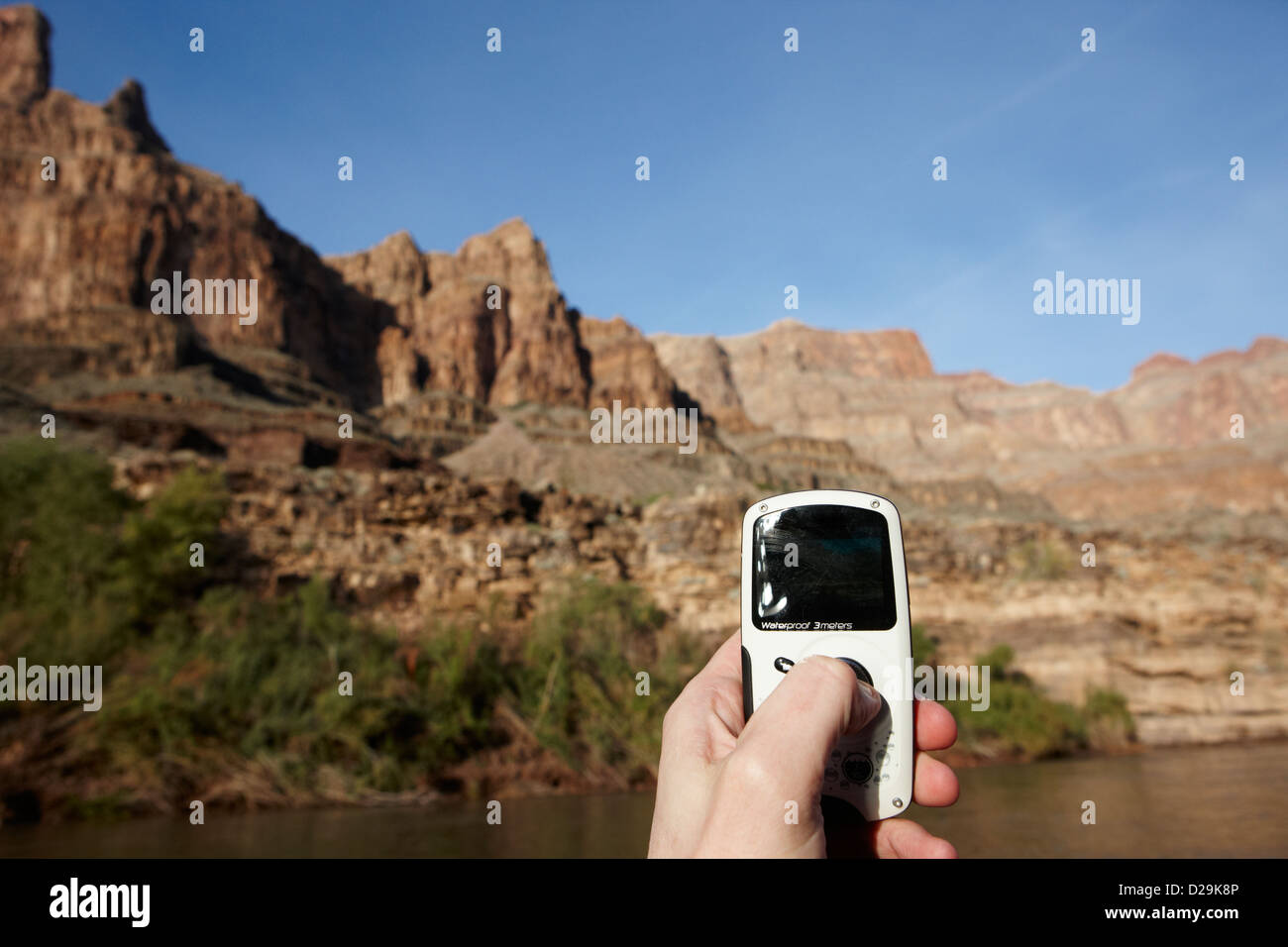 man taking photos and video during boat ride along the colorado river ...