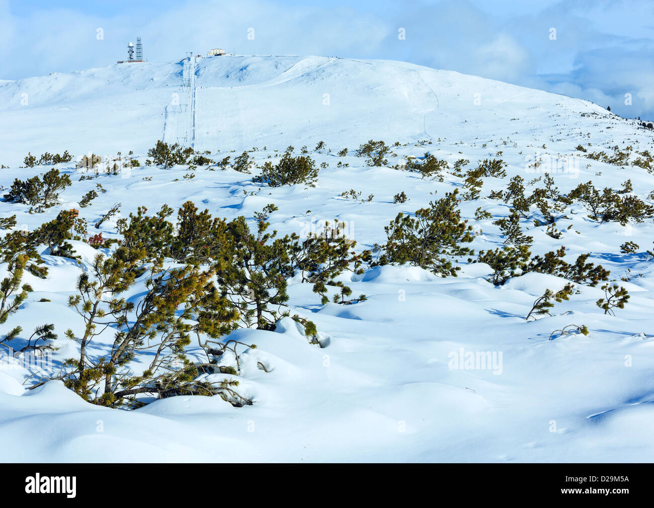 Beautiful winter mountain landscape with ski lift and ski run on slope ...