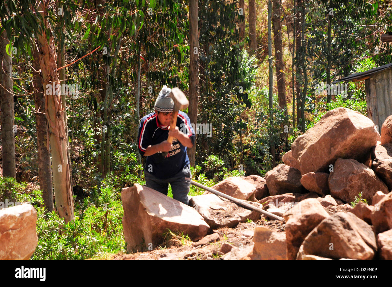 Man Breaking Rocks, Peru Stock Photo - Alamy