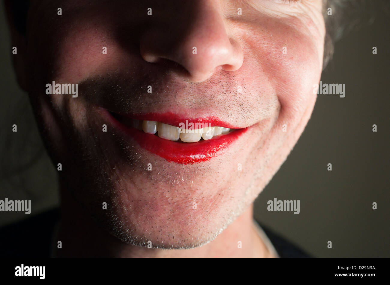 Smiling, unshaven man wearing bright red lipstick Stock Photo - Alamy
