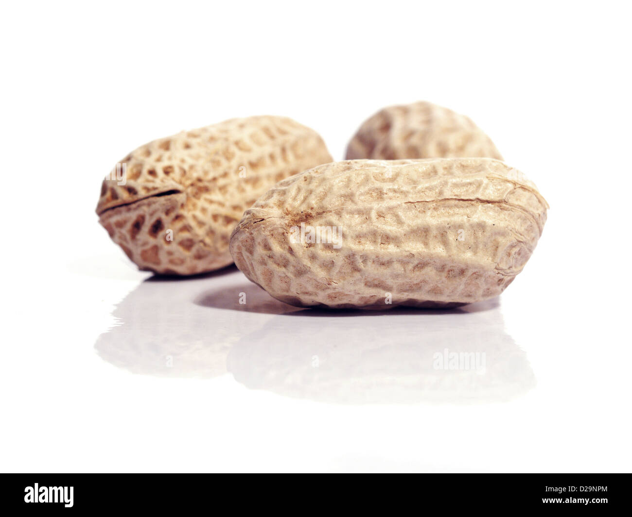Three unshelled peanuts Stock Photo - Alamy
