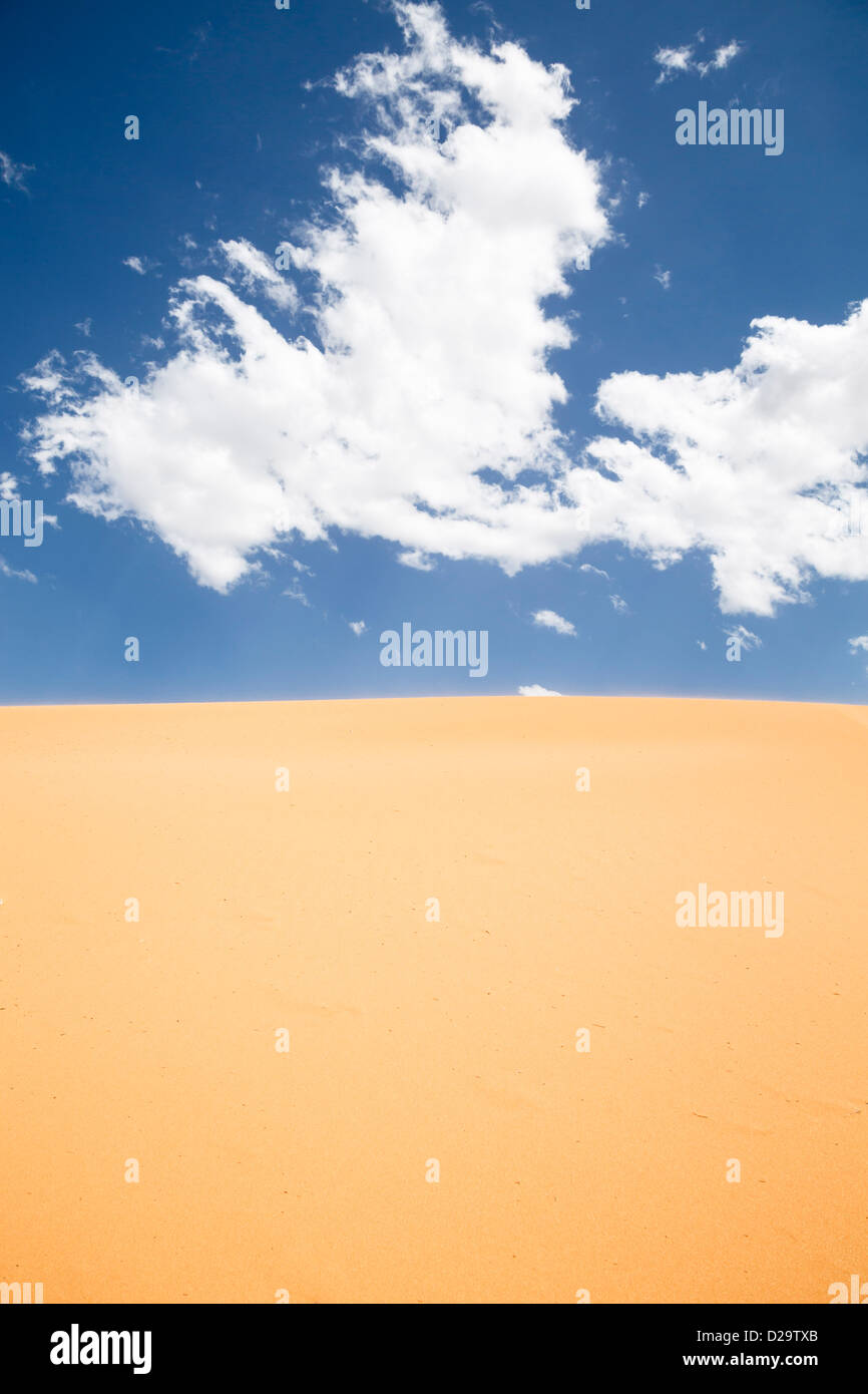 Barren desert landscape with colorful blue sky and clouds Stock Photo ...