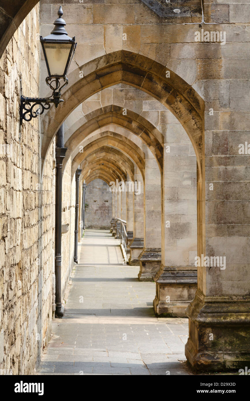 Passage way beside an ancient stone cathedral wall, Winchester ...