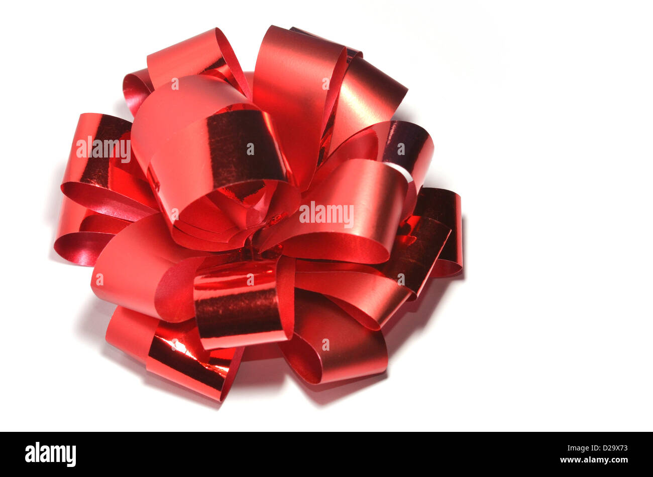 Large red shiny gift bow on white background Stock Photo - Alamy