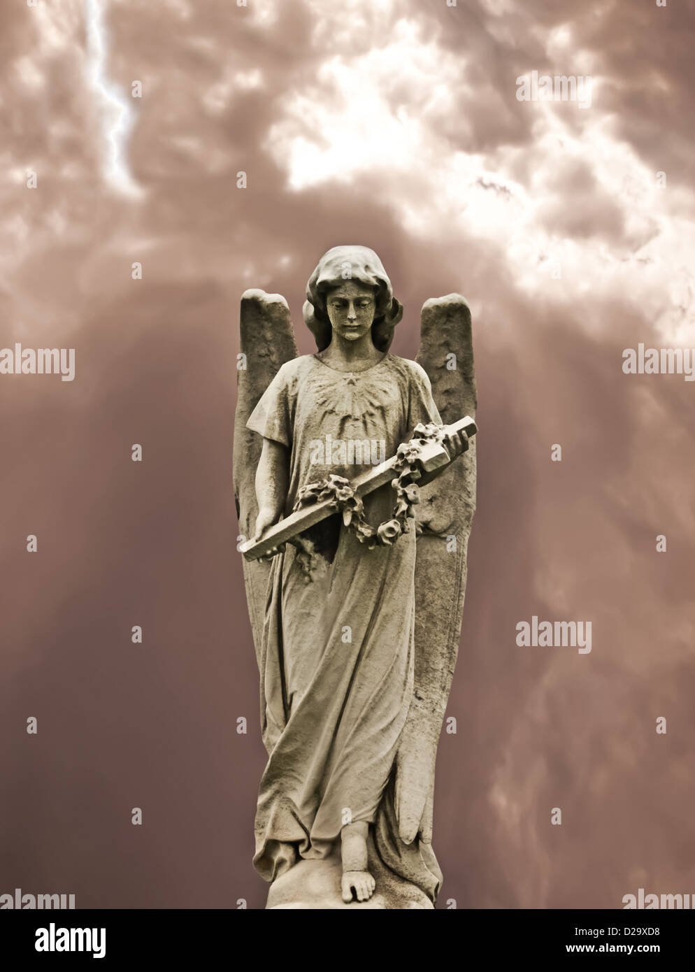 statue of an angel holding cross Stock Photo - Alamy