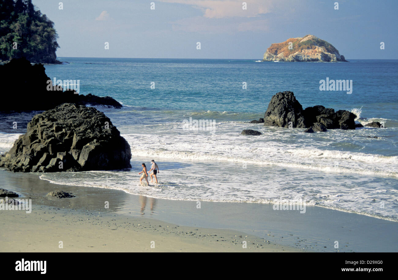 Costa Rica: Manuel Antonio Beach: A Man And Woman Walk Along ...