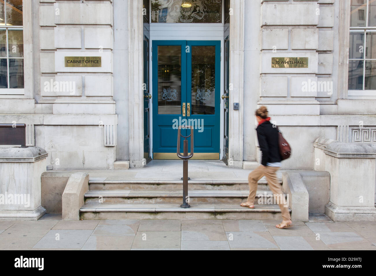 Woman walks up steps prior to entering the Cabinet Office building in ...