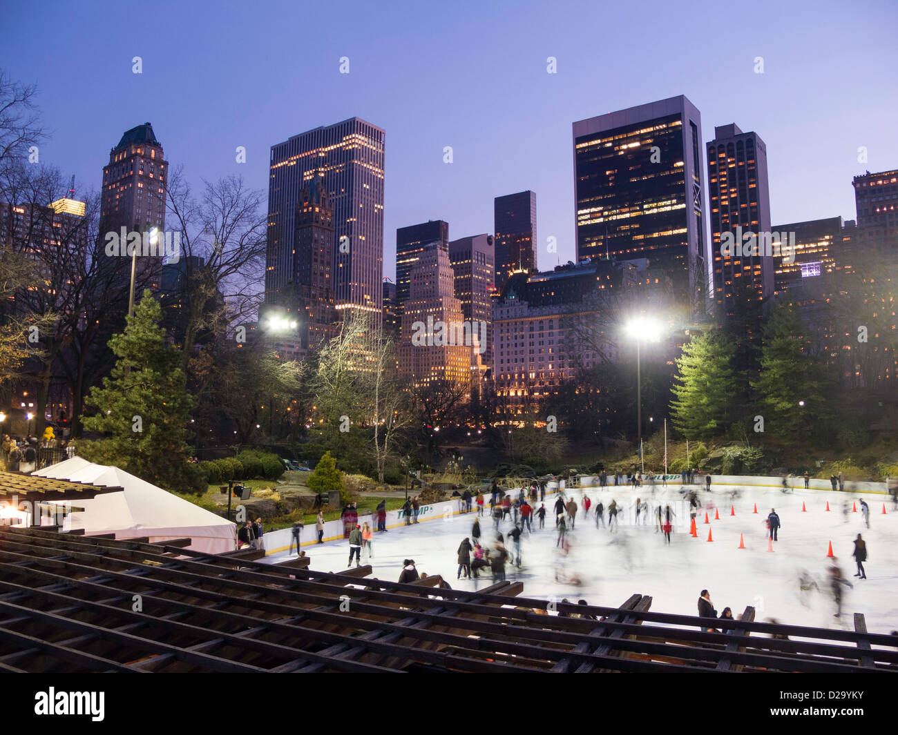 Wollman Rink Ice Skating in Central Park with Manhattan Skyline in ...