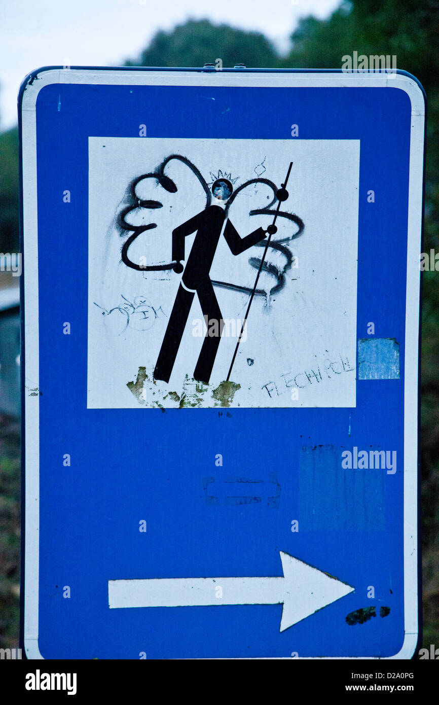 A blue pilgrim road sign that has been painted and decorated, these ...