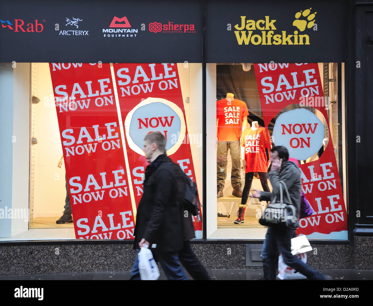 Sale now on sign in shop window of clothing store Stock Photo - Alamy