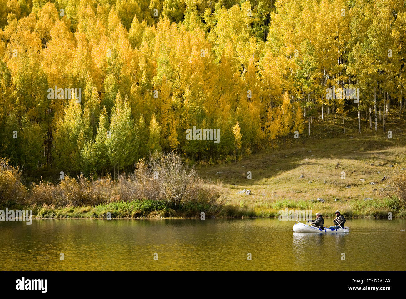 Two adult men fishing in Crystal Lake in autumn near Ouray, Colorado ...