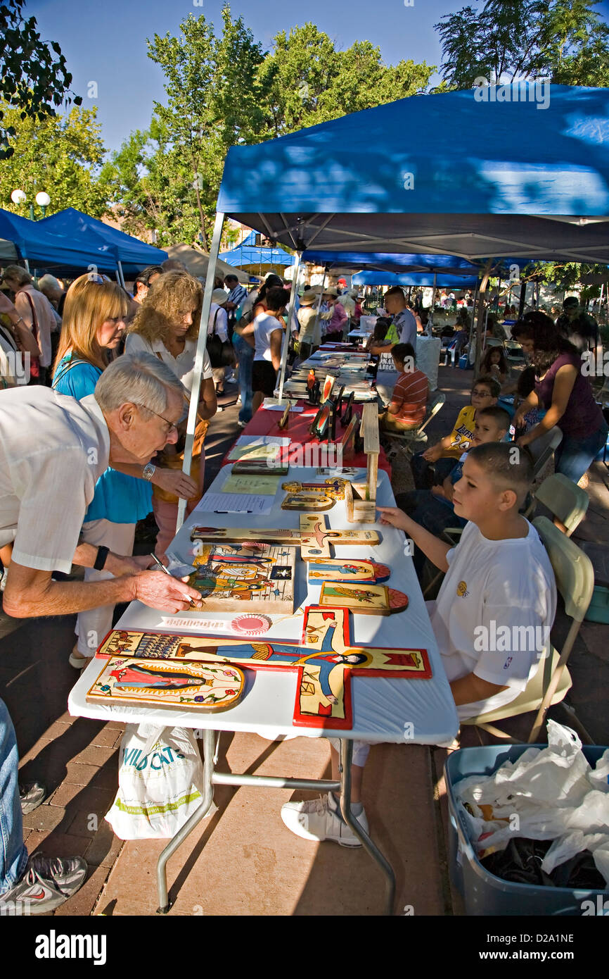 Tourist views youth artist Chris Tapia's display of hand painted ...