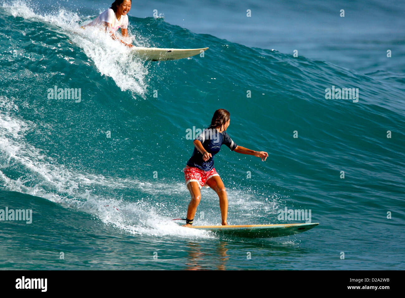 Hawaii, Oahu. Two Girls Surfing At Rocky Point Stock Photo - Alamy