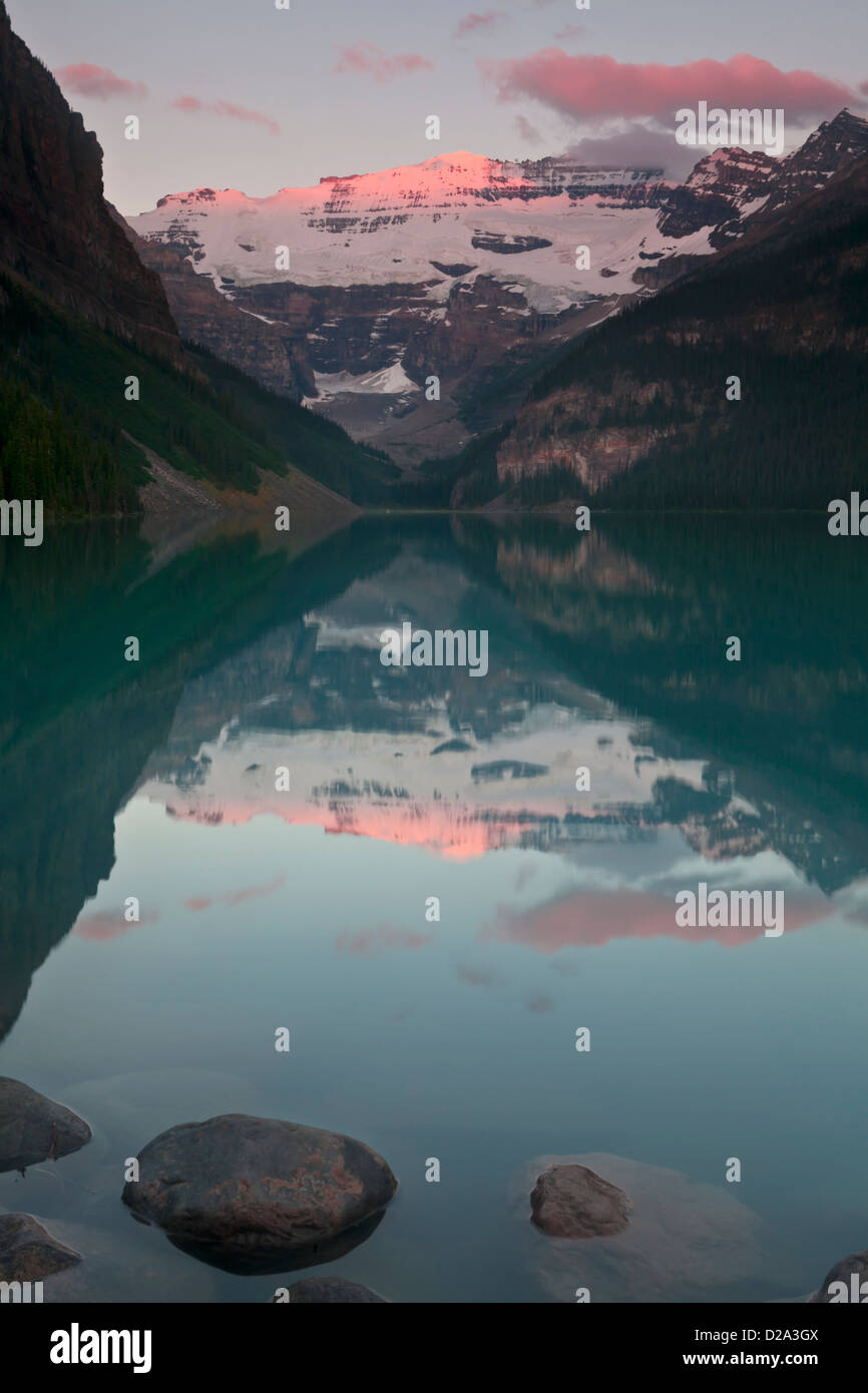 Morning alpenglow on Mount Victoria reflected in Lake Louise, Banff ...
