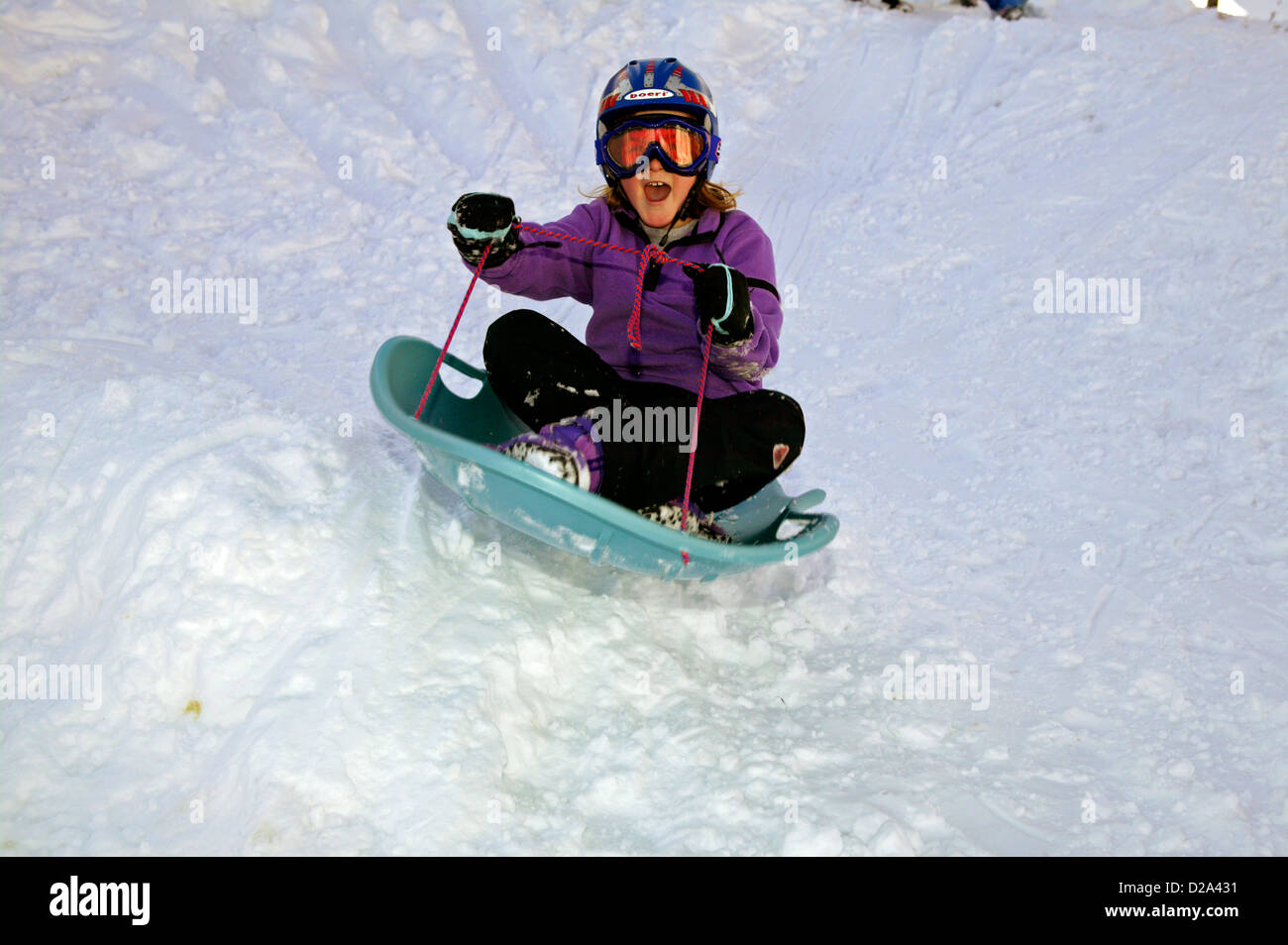 Girl (7) Riding A Sled Stock Photo - Alamy