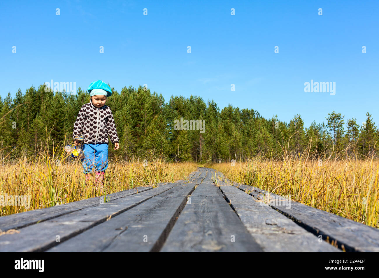 Caucasian small child walking in swamp Stock Photo - Alamy
