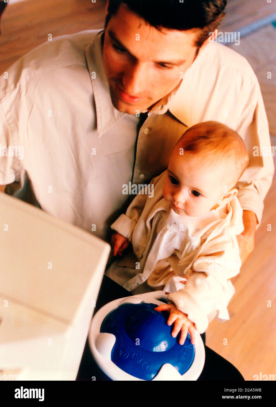 Father At Computer With Baby On His Lap Stock Photo - Alamy
