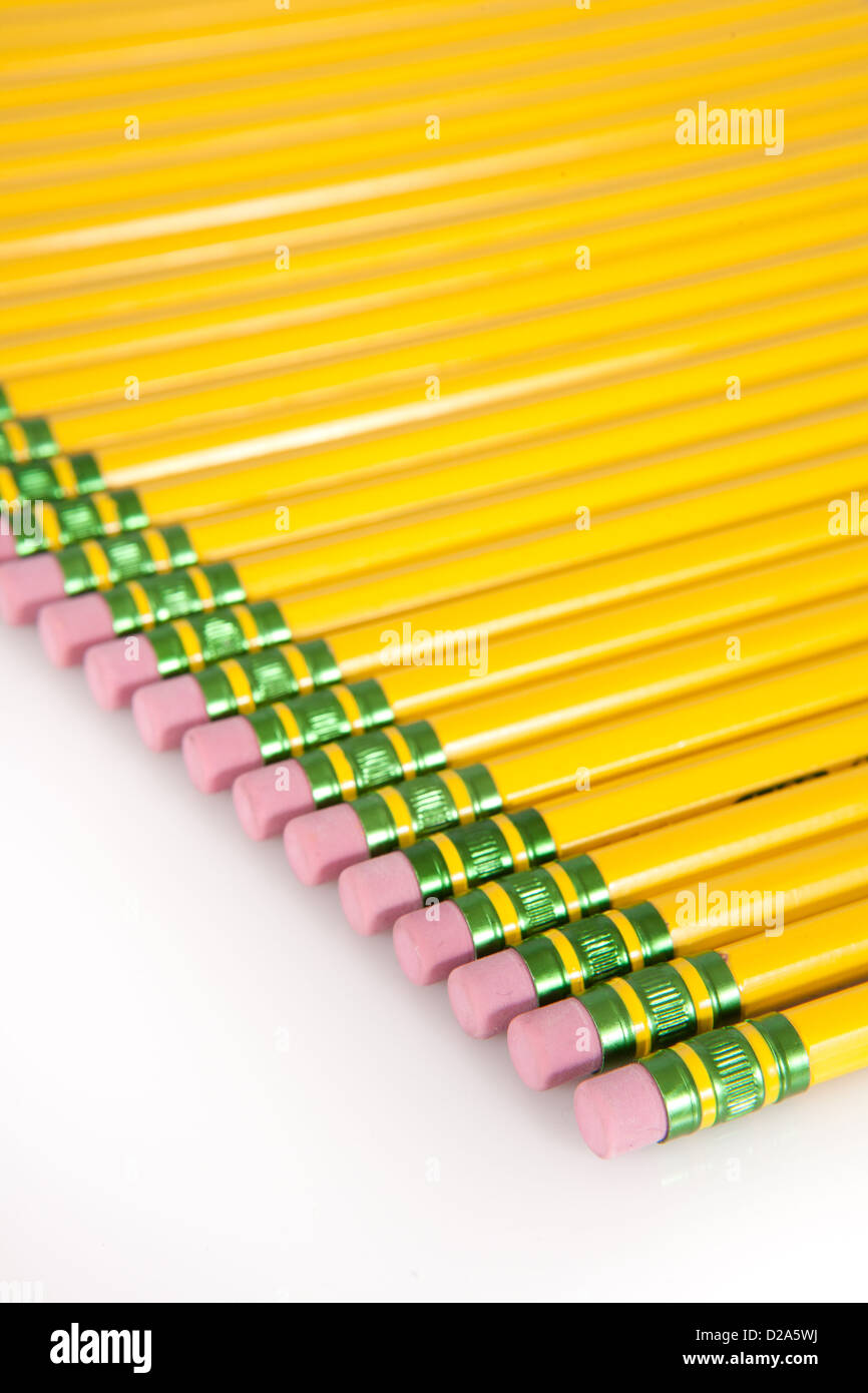 A row of yellow, number 2 pencil erasers lined up on a white background ...
