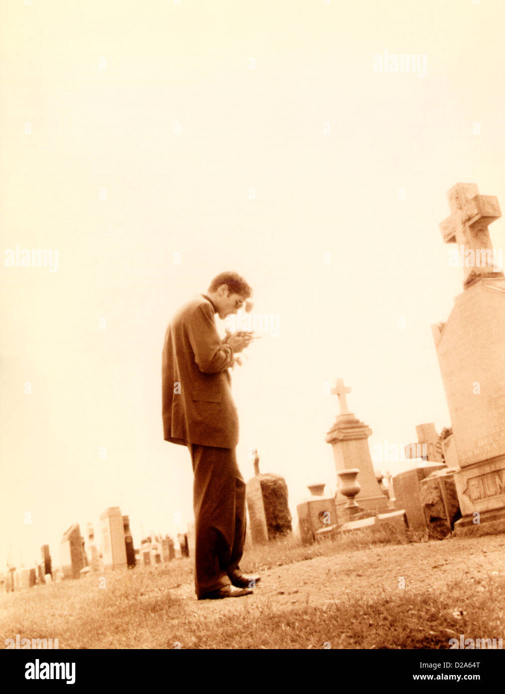 Man At Cemetery, Praying Stock Photo - Alamy