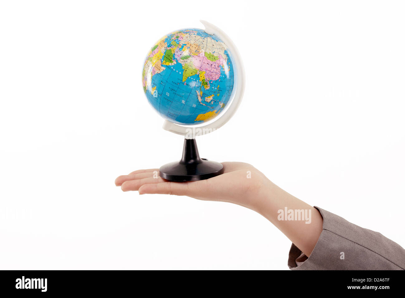A hand holding a globe Stock Photo - Alamy