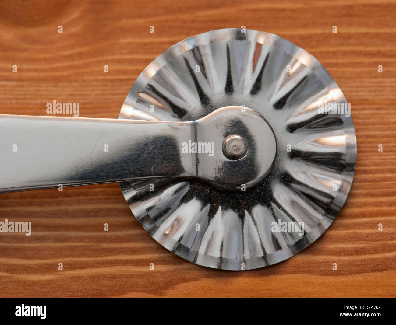 Closeup of pizza and pie cutter Stock Photo - Alamy