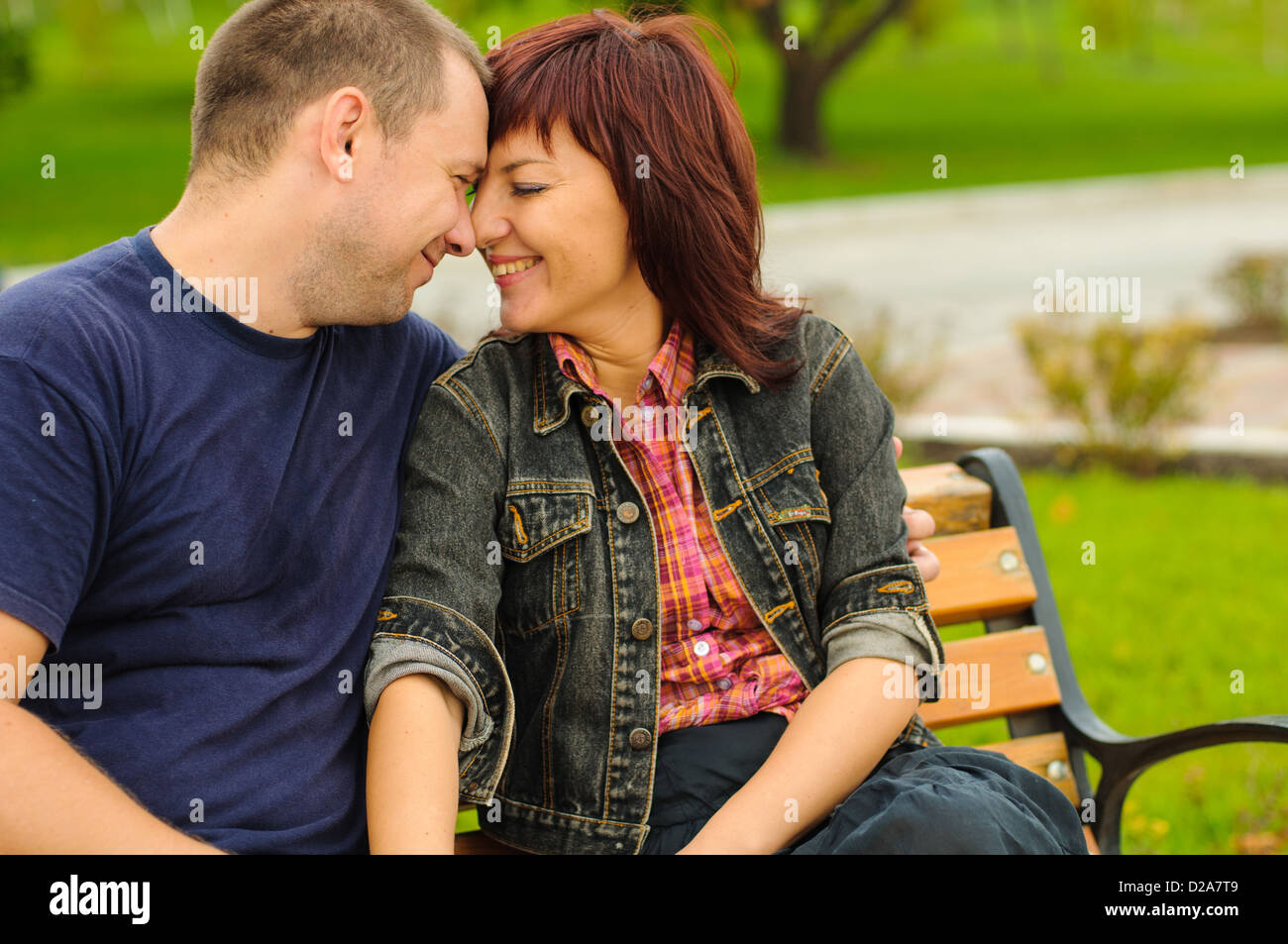 Good looking couple in love smiles each other outdoor Stock Photo - Alamy