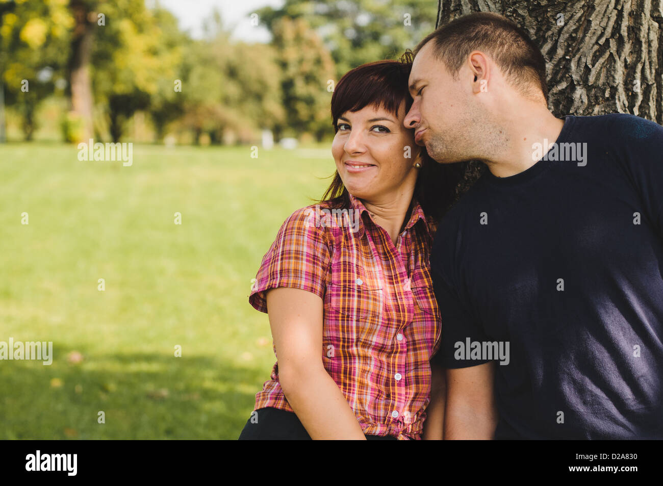 Good looking couple in love smiles each other outdoor Stock Photo - Alamy