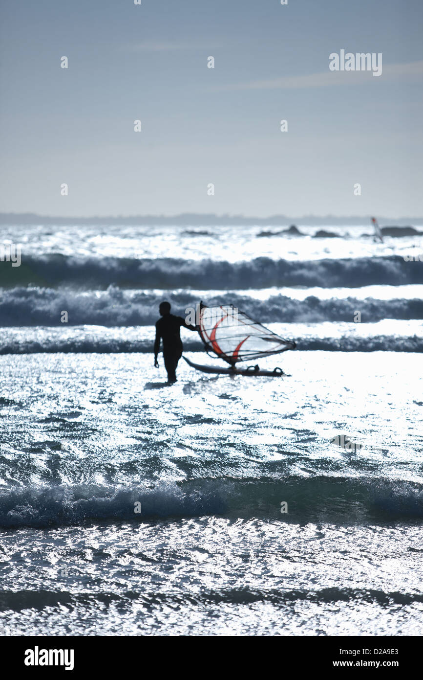 Man with wind sailing board in waves Stock Photo - Alamy