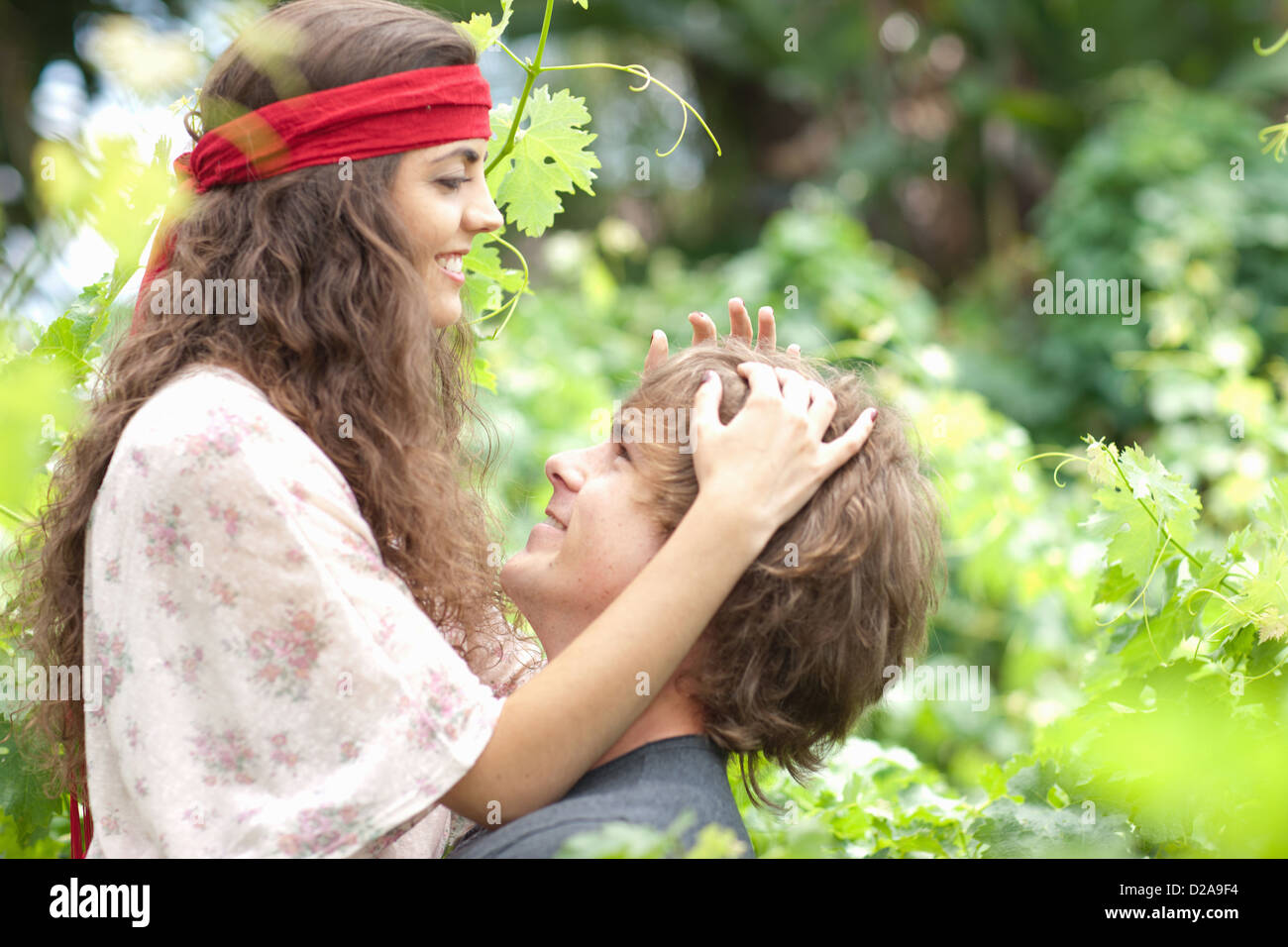 Couple hugging in tall plants Stock Photo - Alamy