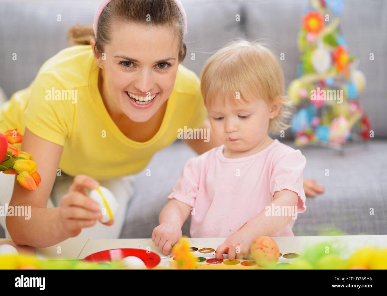 Happy mother and baby making Easter decorations Stock Photo - Alamy