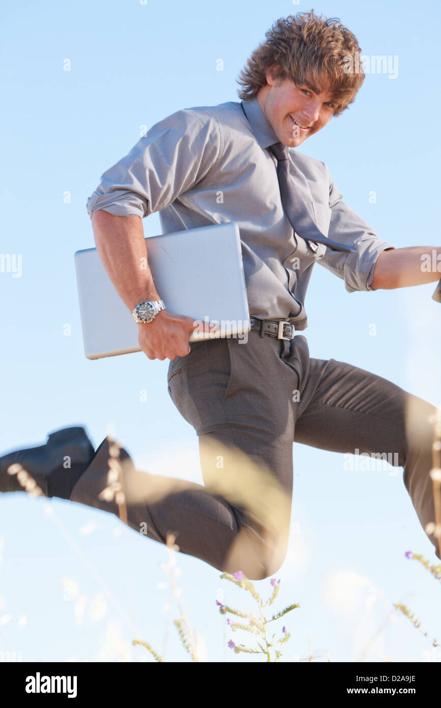 Businessman carrying laptop outdoors Stock Photo - Alamy