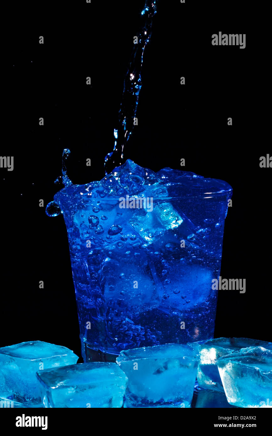 blue cocktail splashing on dark background Stock Photo - Alamy