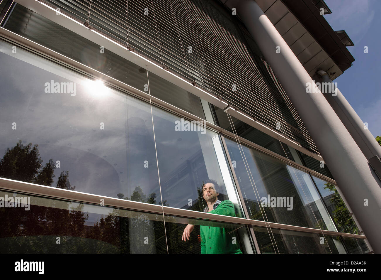 Man standing behind window Stock Photo - Alamy
