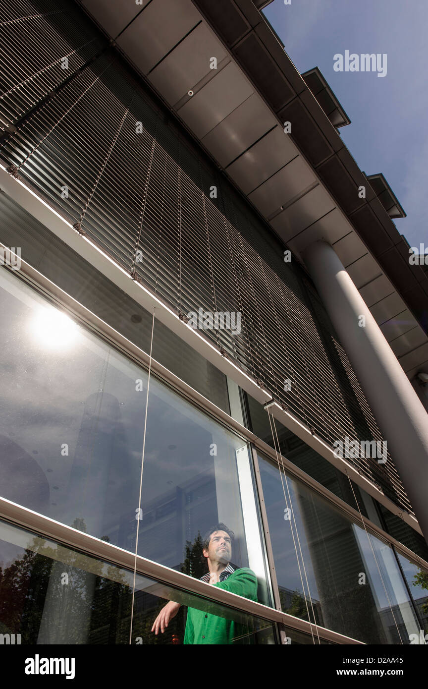 Man standing behind window Stock Photo - Alamy