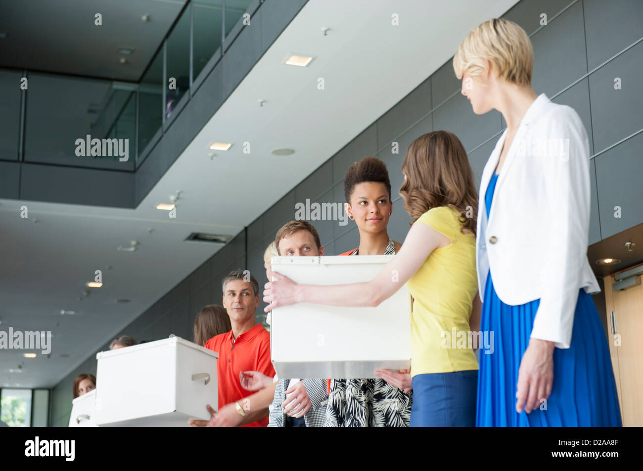 Line of people passing box hi-res stock photography and images - Alamy