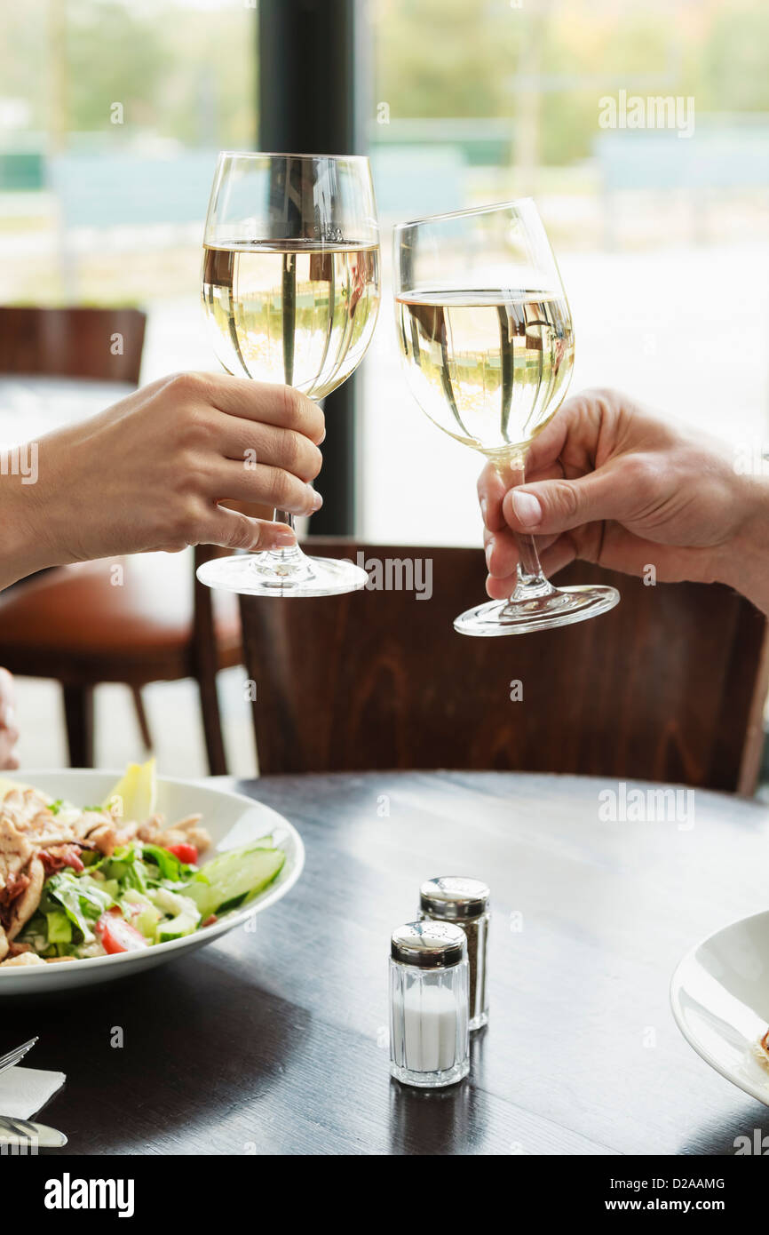 Couple toasting each other at cafe Stock Photo - Alamy