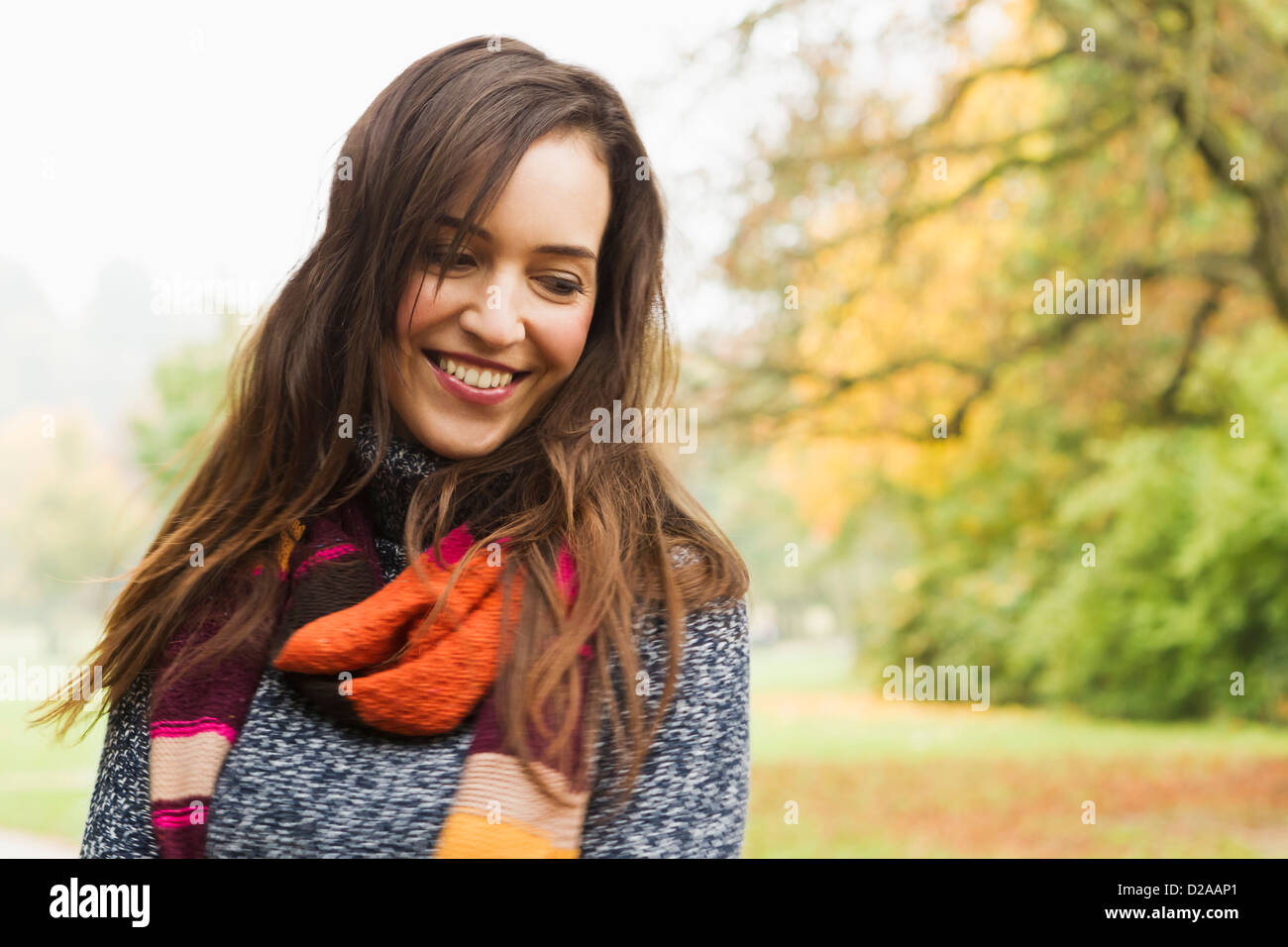 Smiling woman standing in forest Stock Photo - Alamy