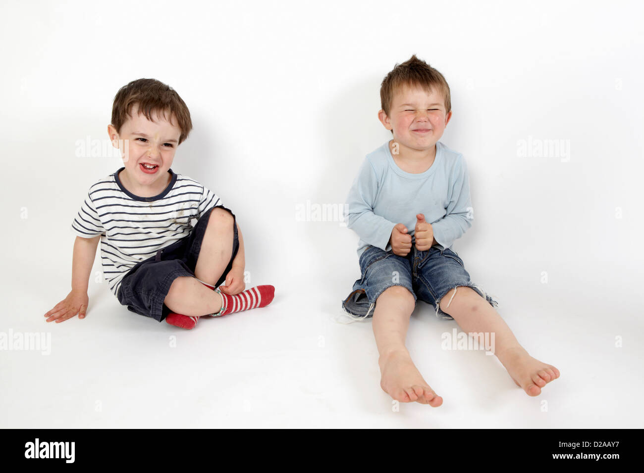 Boys smiling together on floor Stock Photo - Alamy