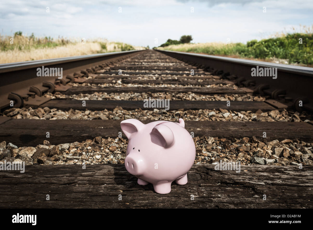 Piggy bank on railroad tracks Stock Photo - Alamy