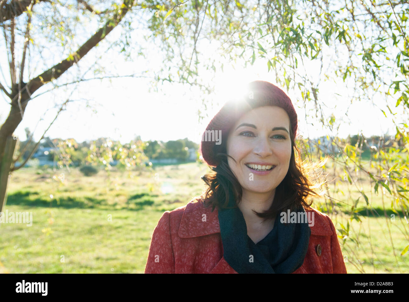 Smiling woman walking in field Stock Photo - Alamy