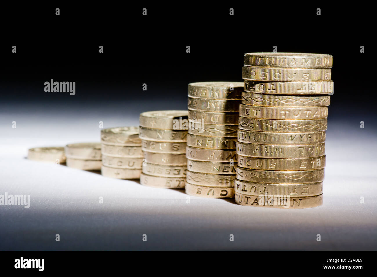 ascending piles of British one pound coins suggesting economic growth ...