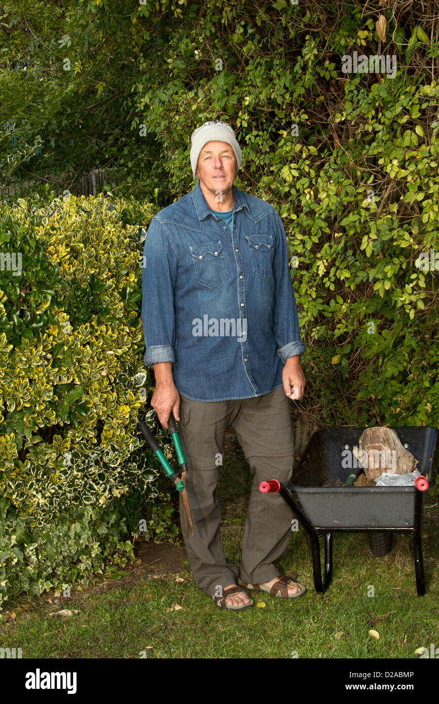 Older man working in garden Stock Photo - Alamy