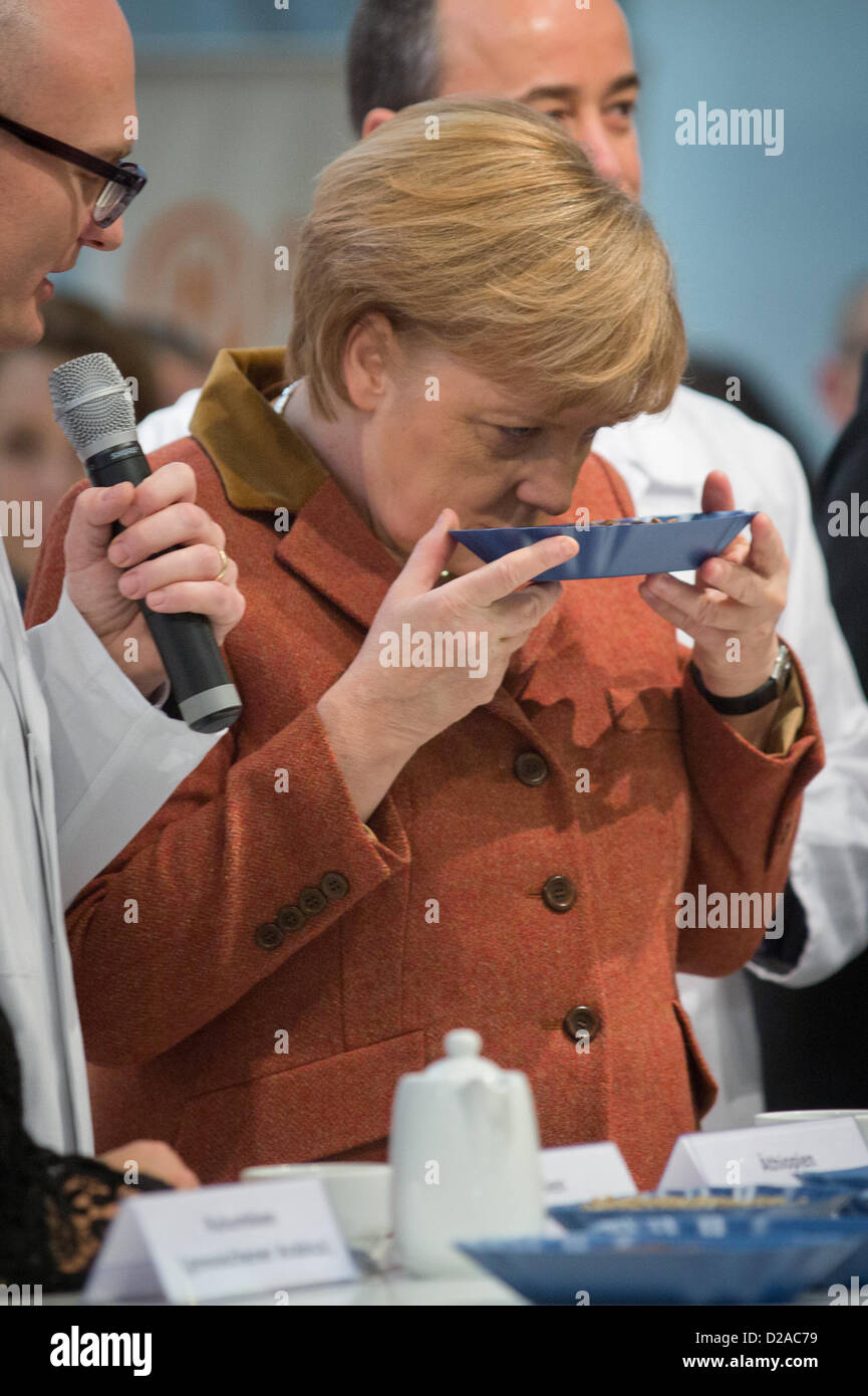 German Chancellor Angela Merkel smells coffee beans at the booth of the ...