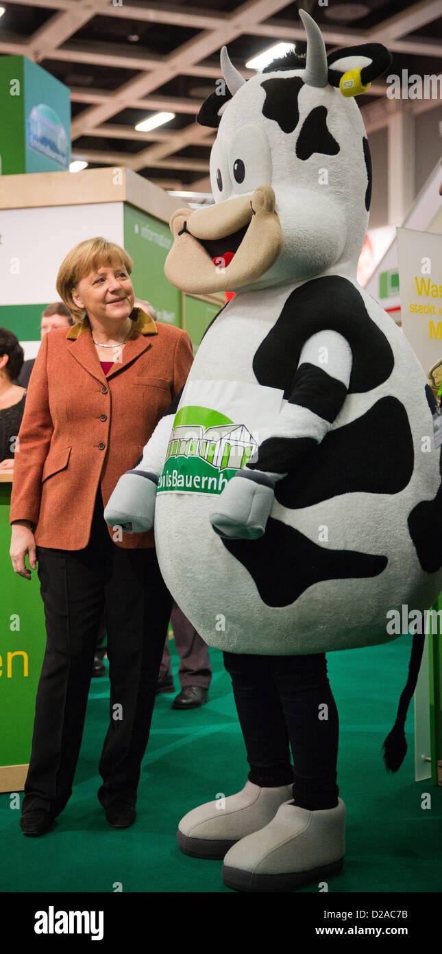 German Chancellor Angela Merkel poses with a soft cow at the adventure ...