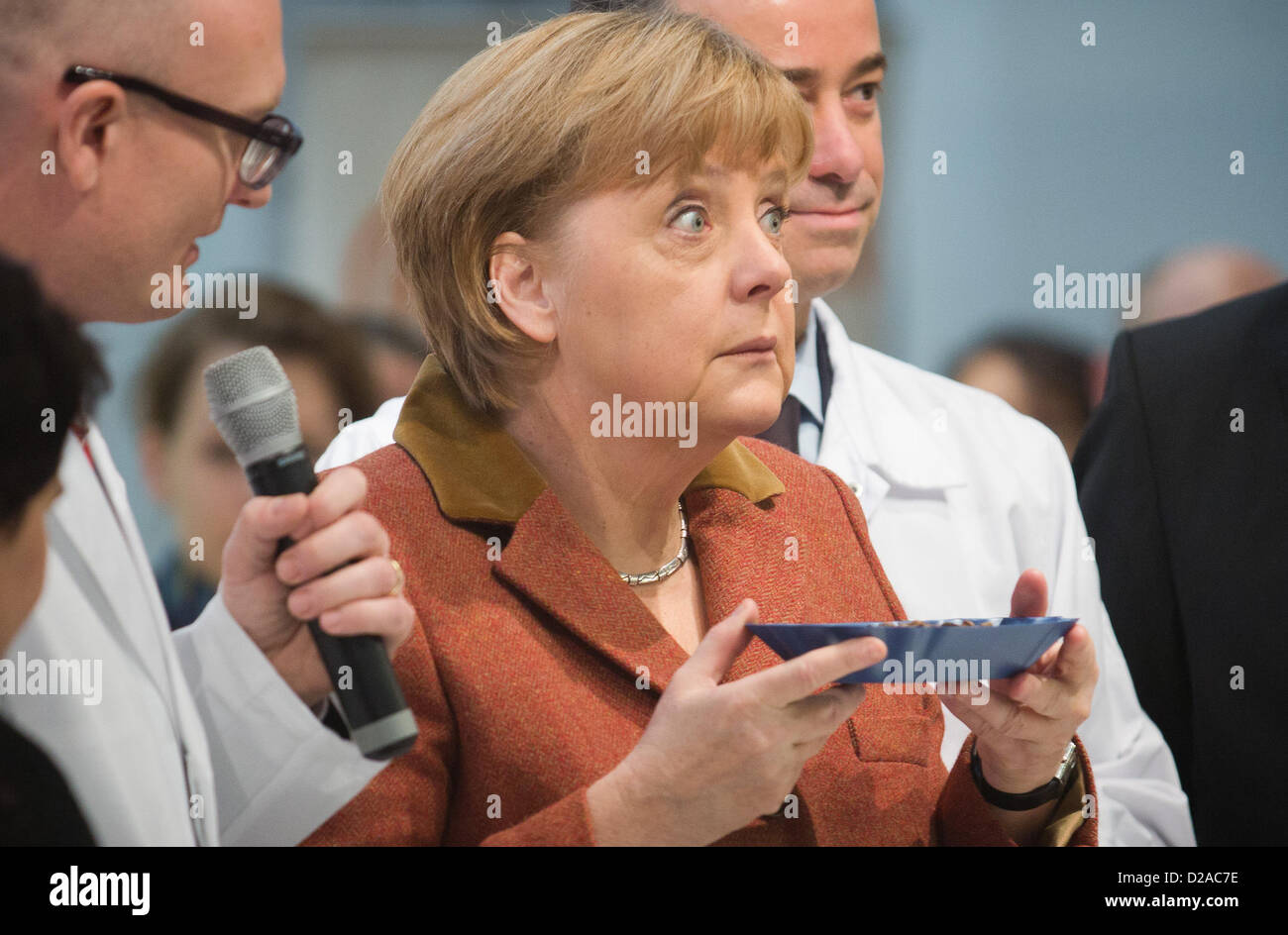 German Chancellor Angela Merkel looks up after she smells coffee beans ...