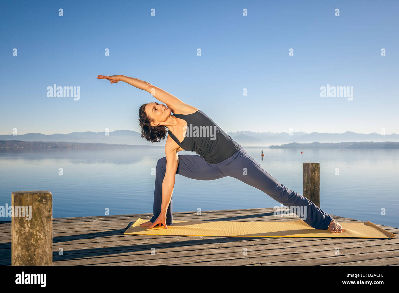 An image of a pretty woman doing yoga at the lake Stock Photo - Alamy
