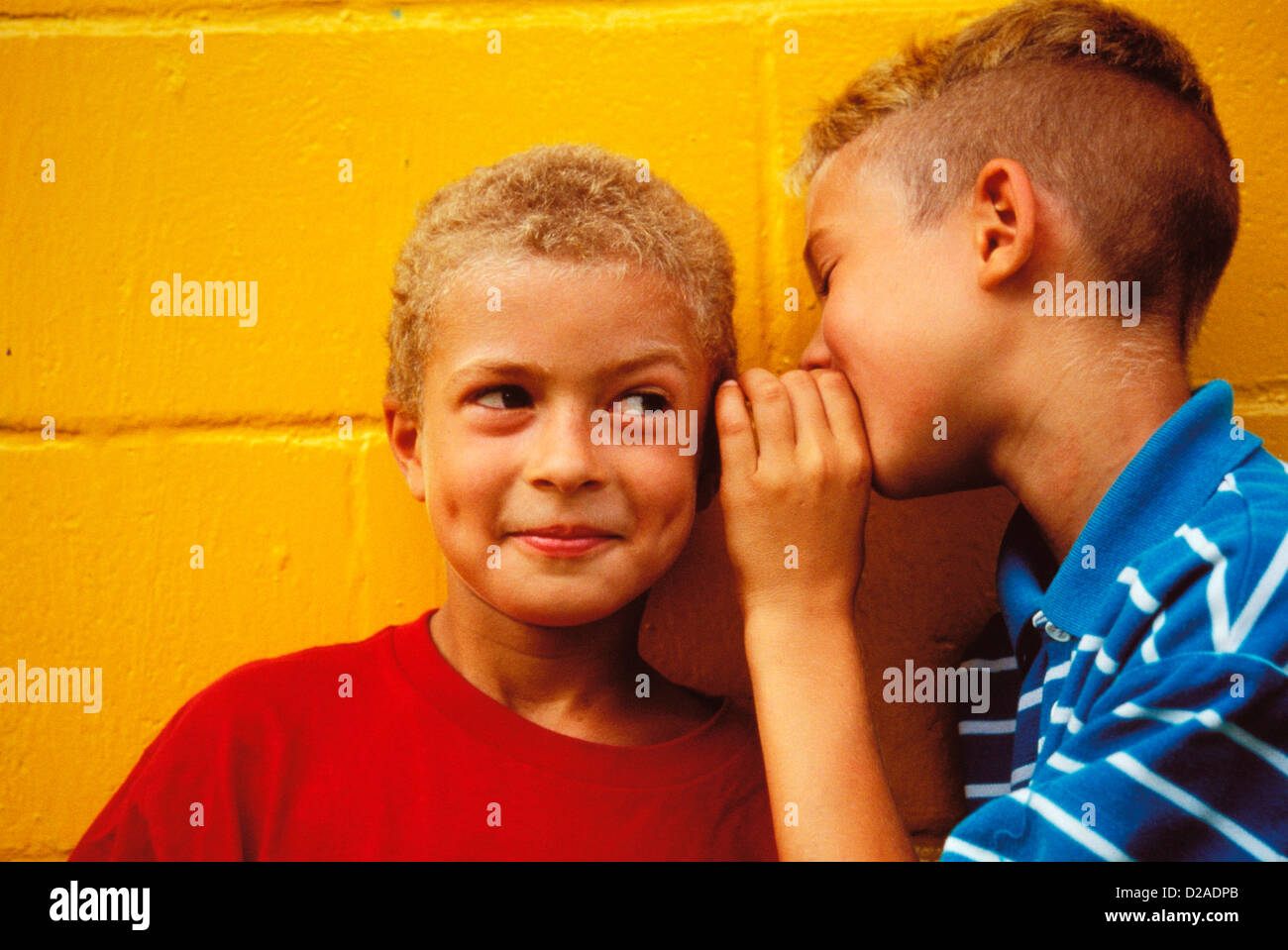 Telling secrets boy hi-res stock photography and images - Alamy