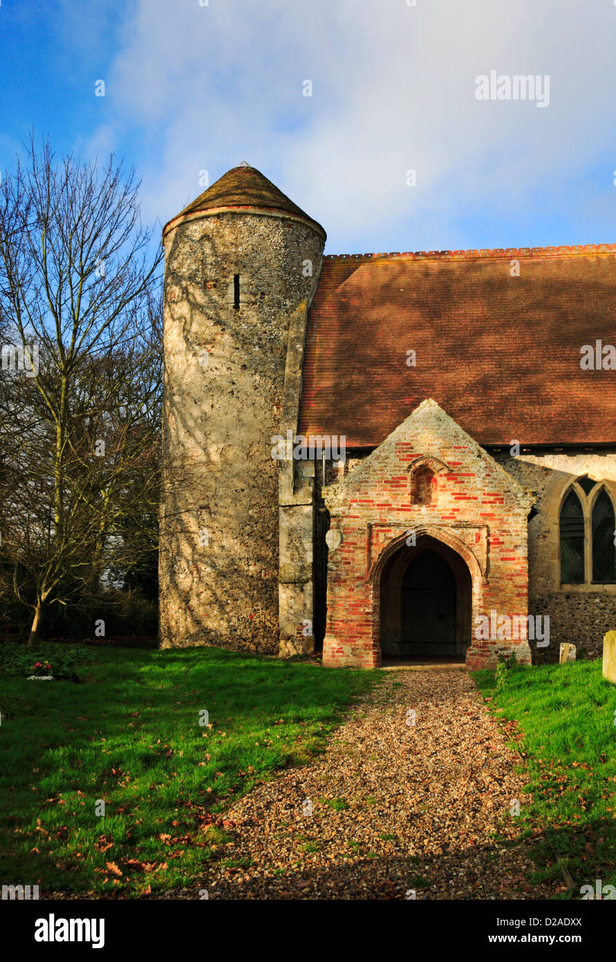 A view of the south porch and round Norman tower of the church of St ...