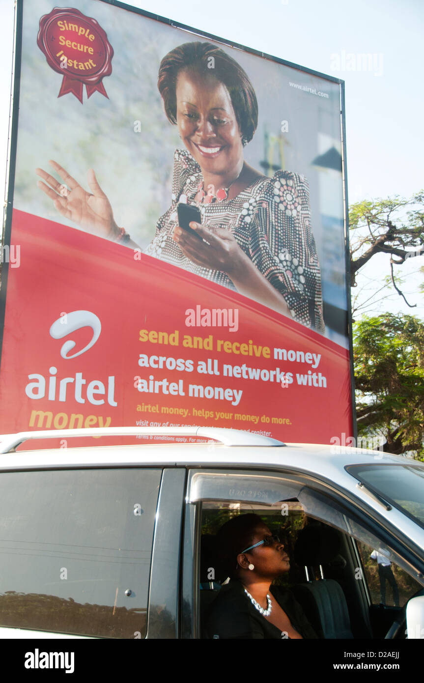 Kampala - mobile phone advert above woman driver wearing a pearl ...